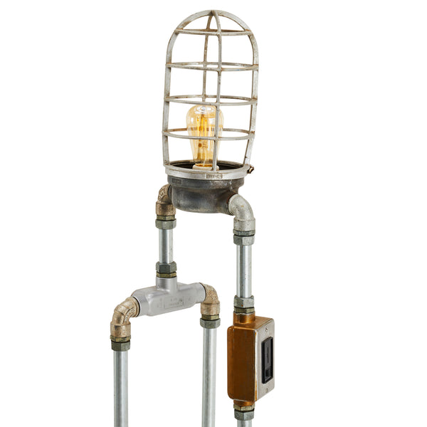 Grey Metal Industrial Triangle Pipe Floor Lamp - Gil & Roy Props